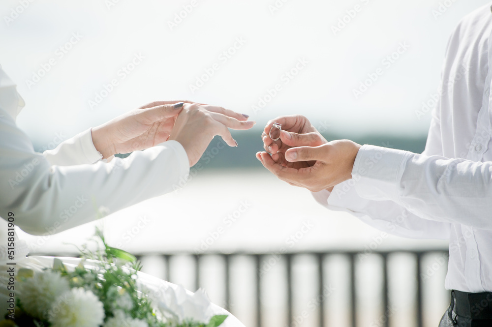 muslim groom in white dress wear wedding rings to left ring finger of ...