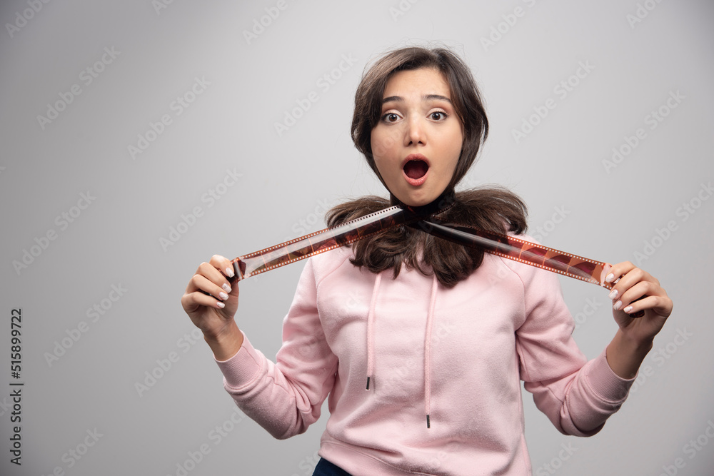 Female photographer choking herself with filmstrip Stock Photo | Adobe ...