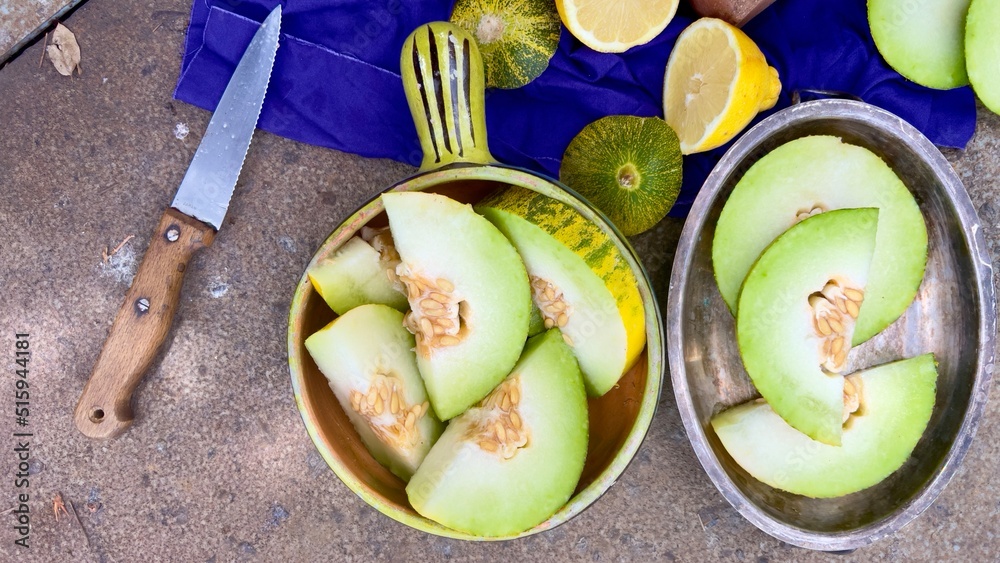 Sliced green sweet melon in vintage glazed clay pot above view Stock ...