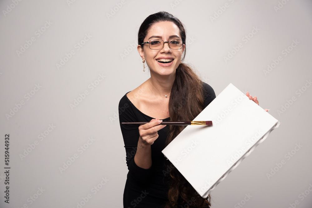 Young artist girl showing her artwork to the public and explaining ...