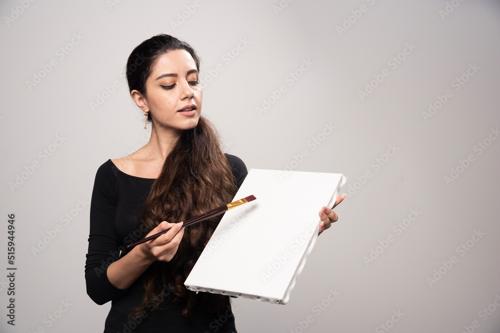 Young artist girl showing her artwork to the public and explaining ...