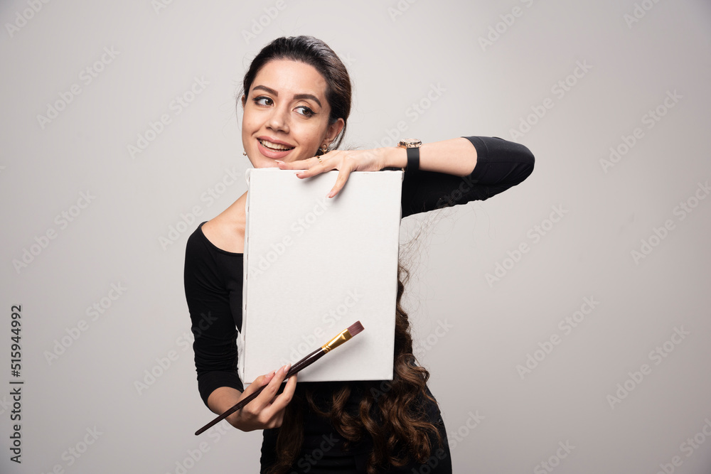 Young artist girl showing her artwork to the public and explaining ...
