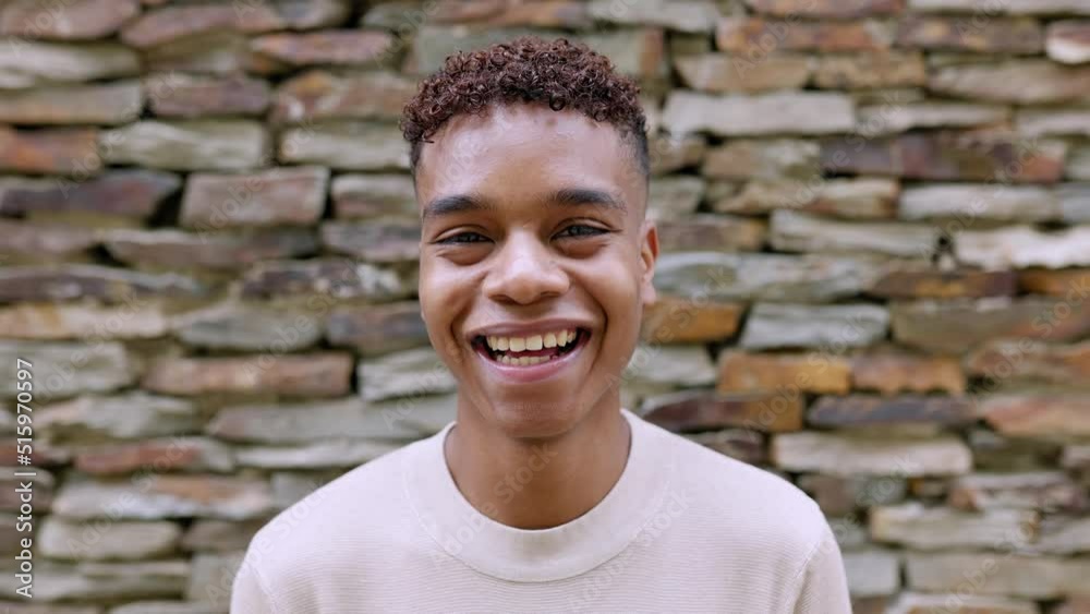 Portrait of happy young adult ethnic man outdoor. Millennial hispanic ...