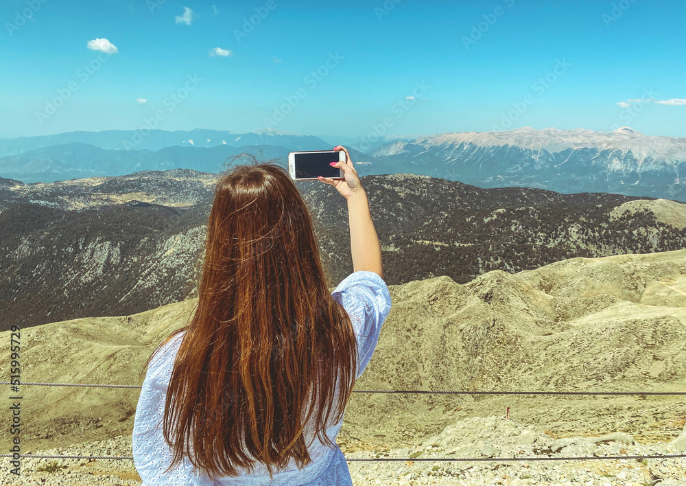a girl in a white dress with long, dark hair on the observation deck ...