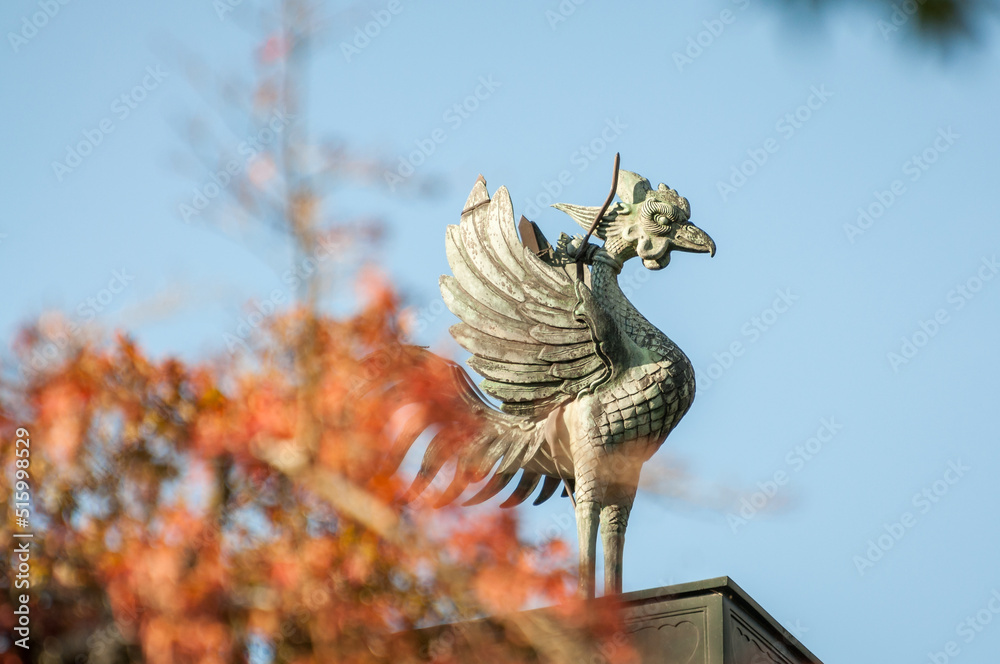 Traditional bird sculpture on top of the roof of one of the buildings ...