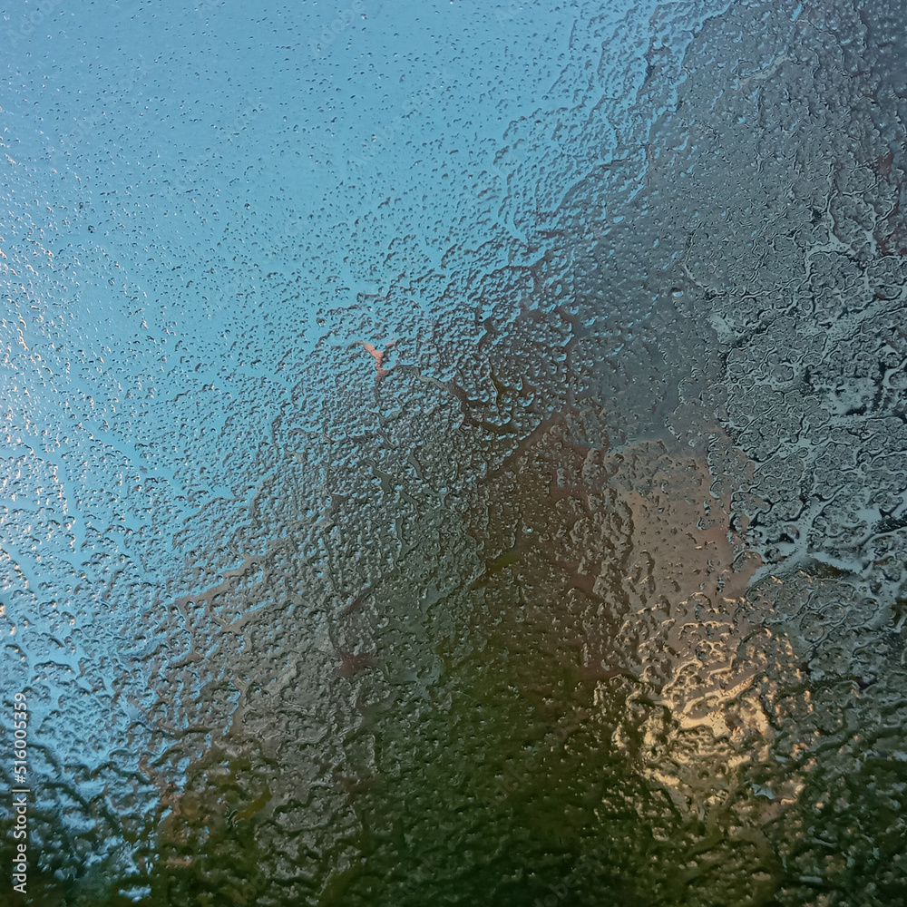 Frozen glass with the onset of cold weather. View through a layer of ...