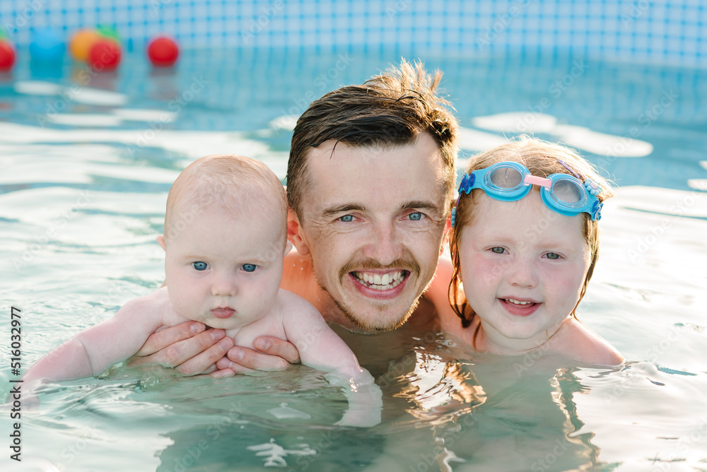Father and kids having fun in the swimming pool. Summer leisure and ...