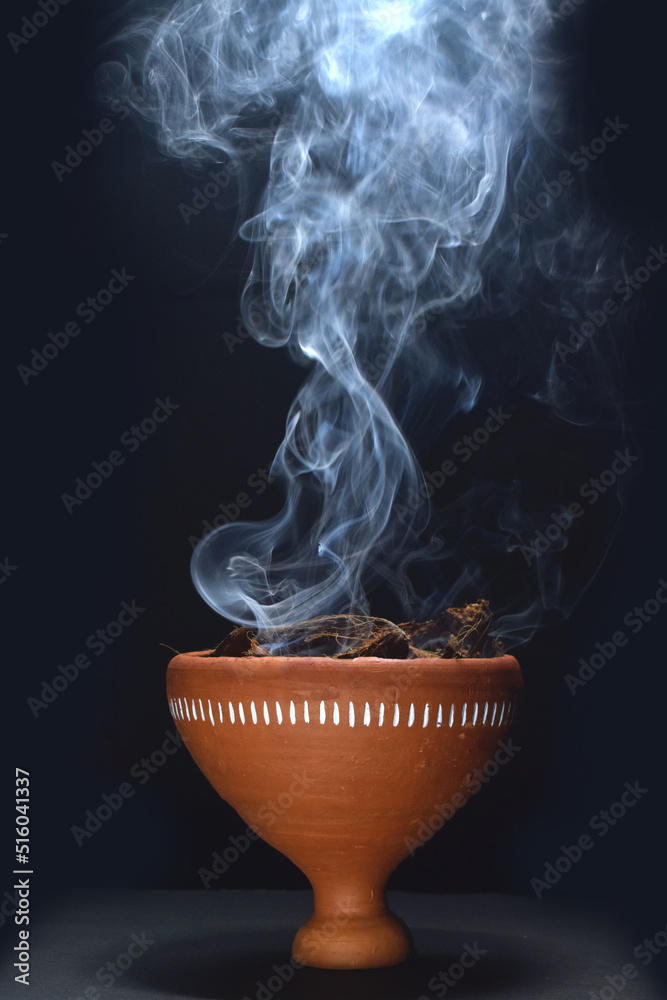 Durga puja dhunuchi with smoke isolated on black background. Stock ...