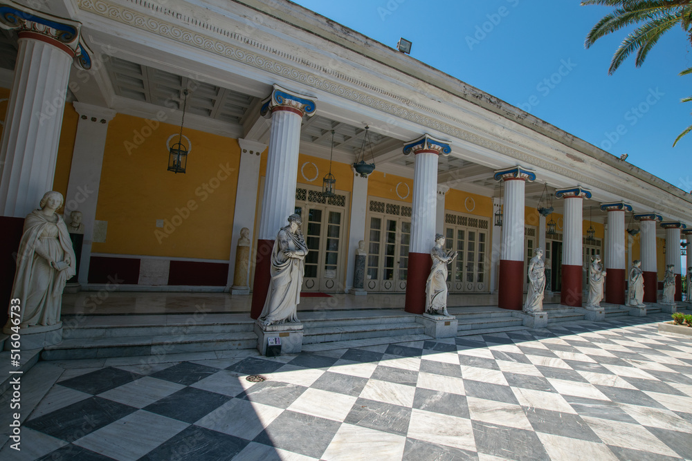 External luxurious marble ionian columns with statues at an old mansion ...