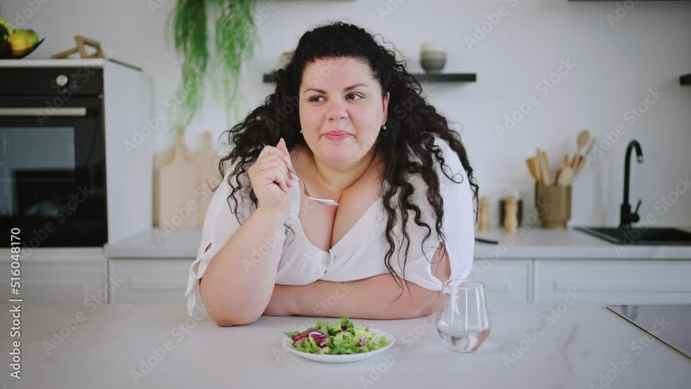 Young overweight woman enjoys life eating healthy food Stock Video ...