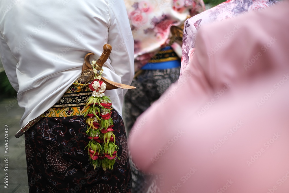 Asian Man wearing traditional Javanese attire with keris. Keris is a ...