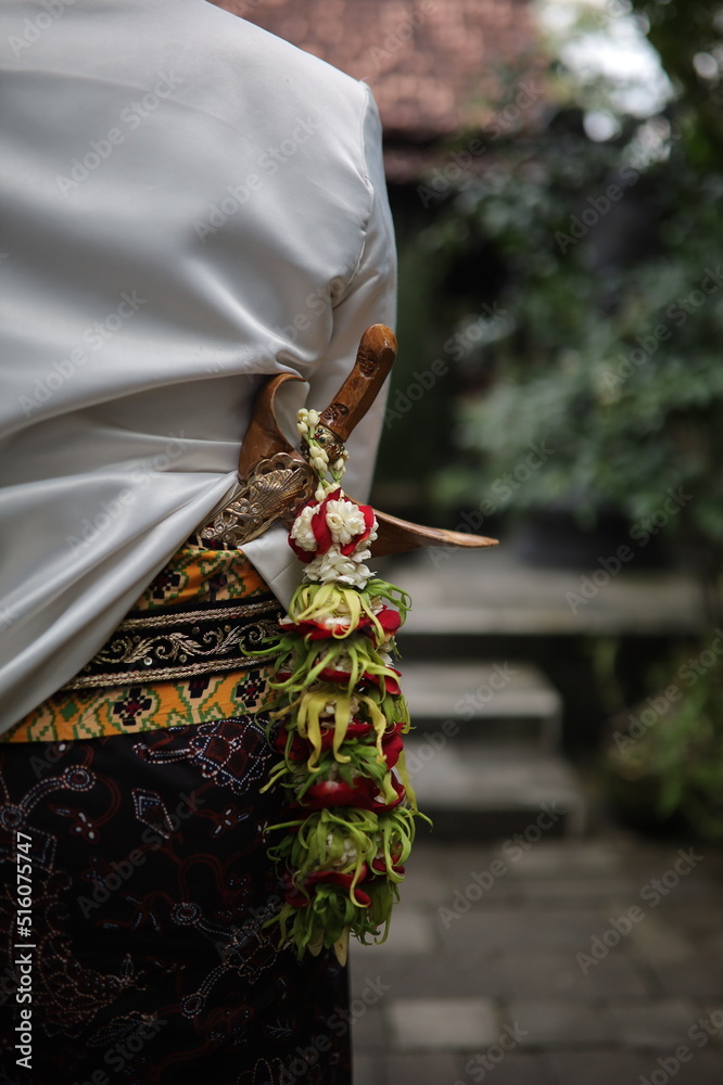 Asian Man wearing traditional Javanese attire with keris. Keris is a ...