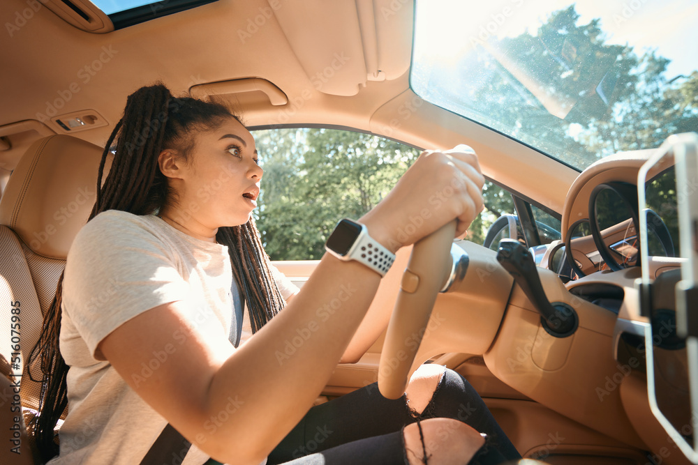 Frightened shocked young woman driving passenger car Stock Photo ...