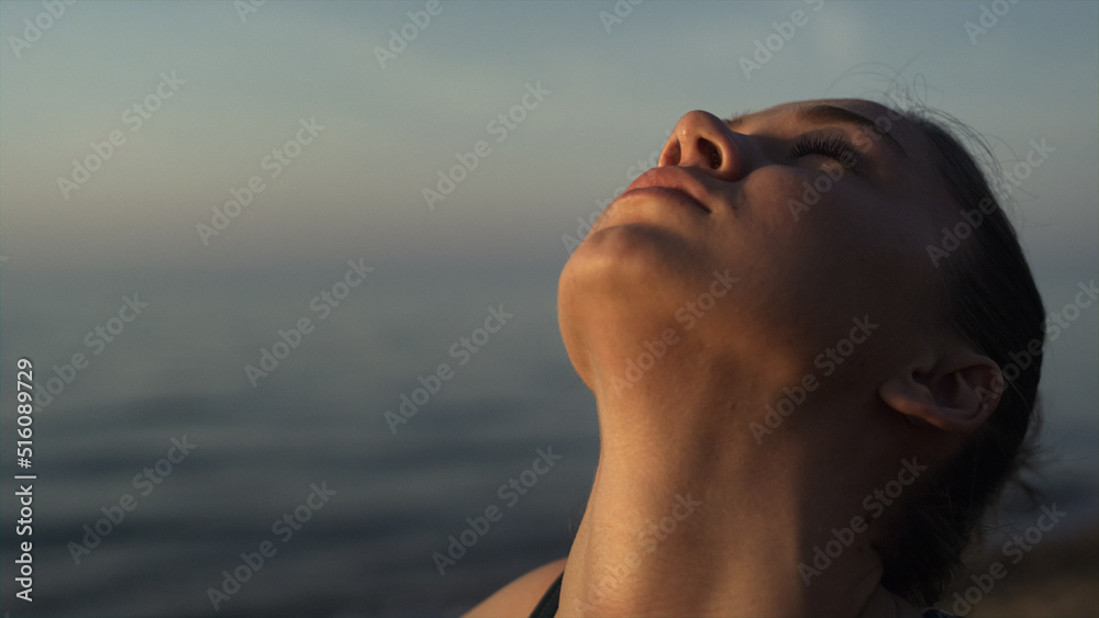 Relaxed girl bending neck standing plank pose on beach closeup. Woman ...