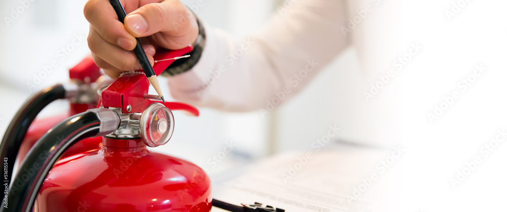 Fire extinguisher has hand engineer inspection checking pressure gauges ...