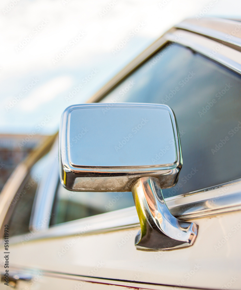 Classic car background. Close-up of the side mirror of a classic design ...