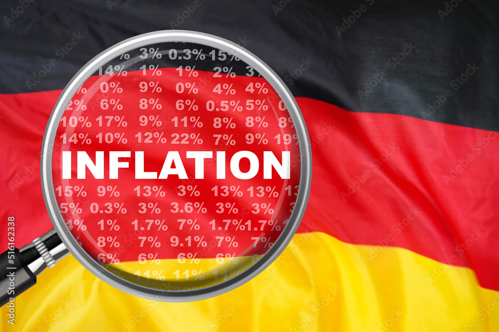 Magnifying glass focused on the word inflation on Germany flag ...