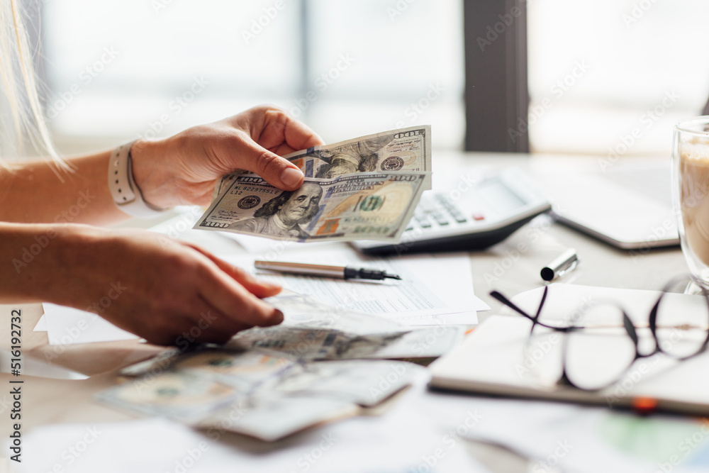 Close up young business woman using counting cash money one hundred ...