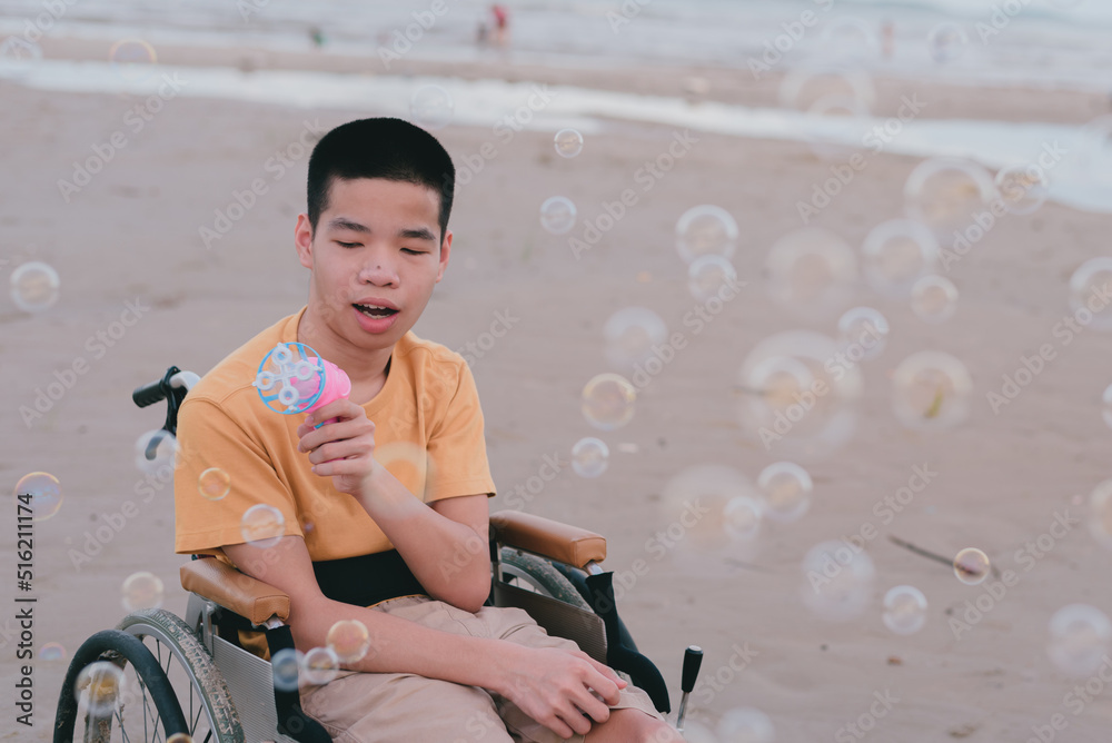 Young man with disability playing bubble shooter toy gun. It is a ...