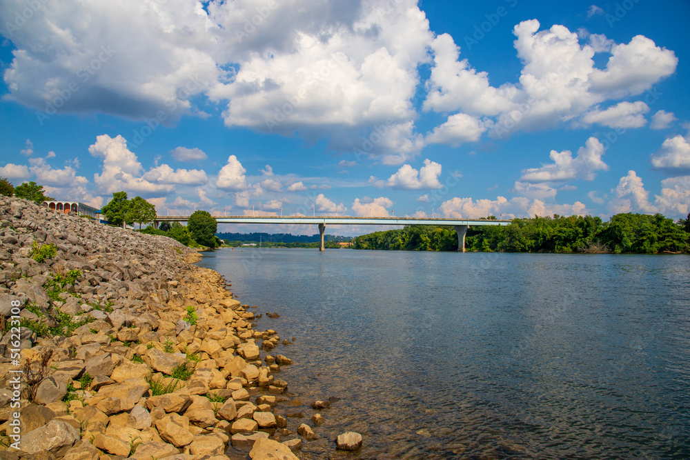 the vast blue rippling waters of the Tennessee river with rocks along ...