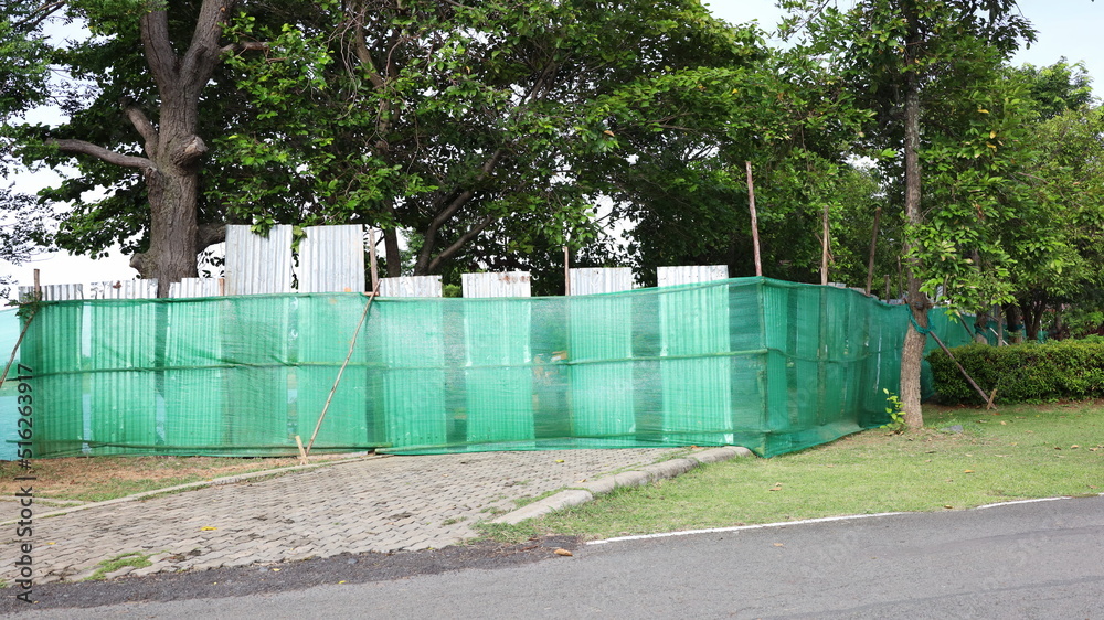 Metal fences and synthetic fabrics of the construction zone. Workplace ...