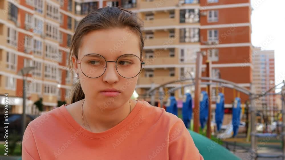 A lonely 16-year-old girl is sad on a deserted playground about a ...
