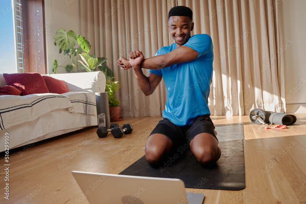 Young black African American happy working out at home stretching his ...
