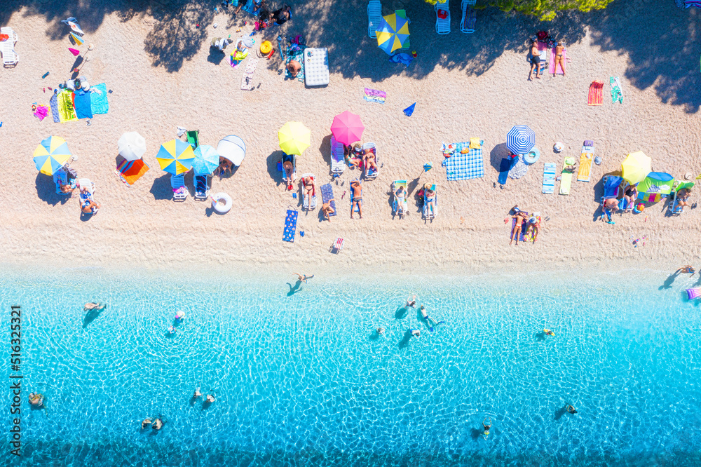 Aerial view on beach, pepole and umbrellas. Vacation and adventure ...