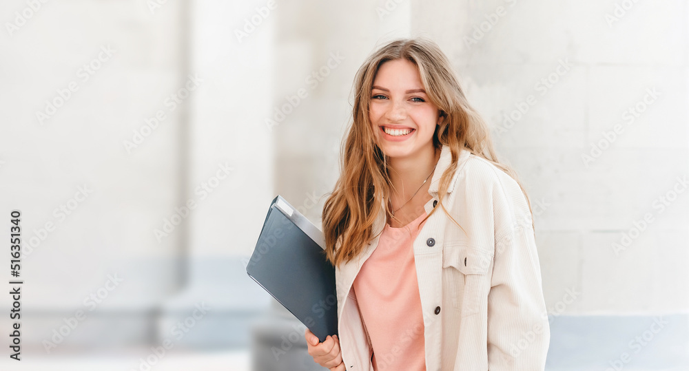 Young blonde student girl smiling against university. Cute girl student ...