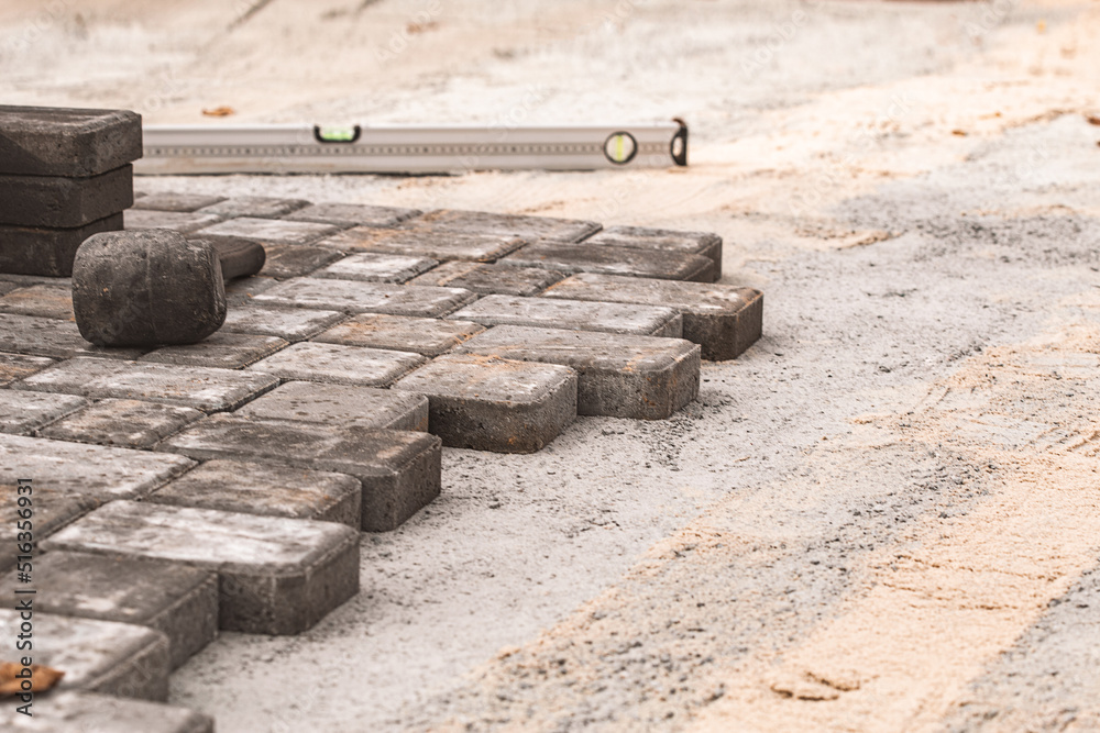 Foto de Laying paving slabs close-up. Road surface, construction ...