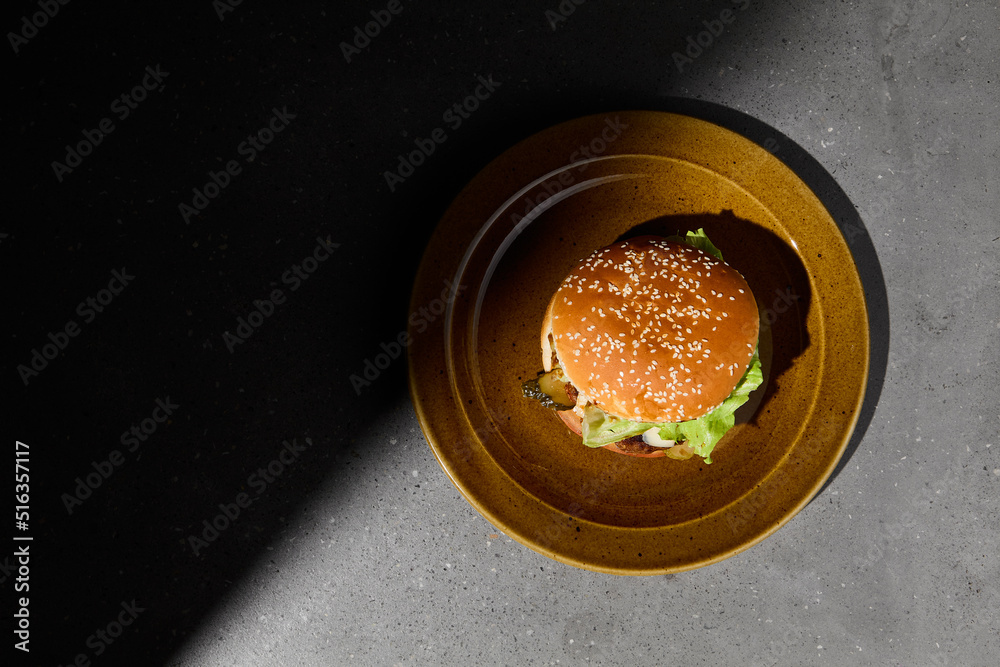 Classic american burger on ceramic plate in dark minimal style. Beef ...