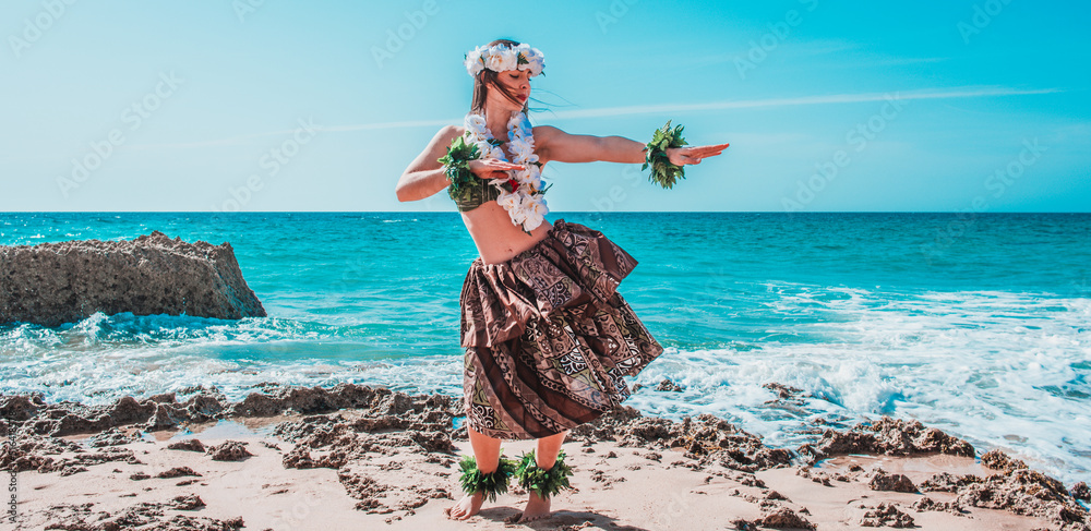 Hula dancer on the beach. Woman in bikini dancing Hawaiian typical of Tahiti. Tropical lady at ...