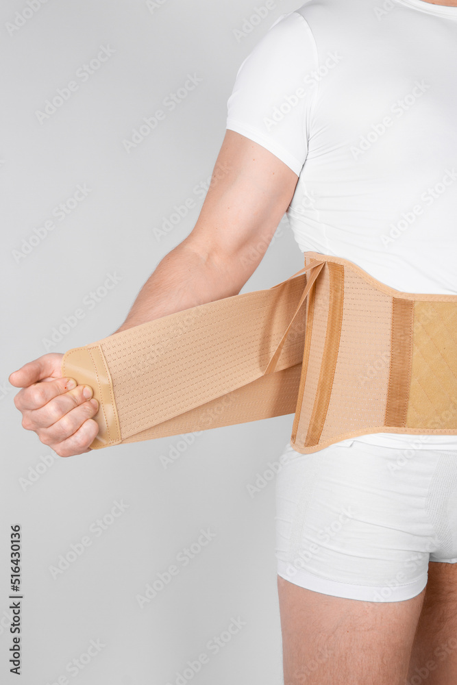 Orthopedic lumbar corset on the human body. Back brace, waist support ...