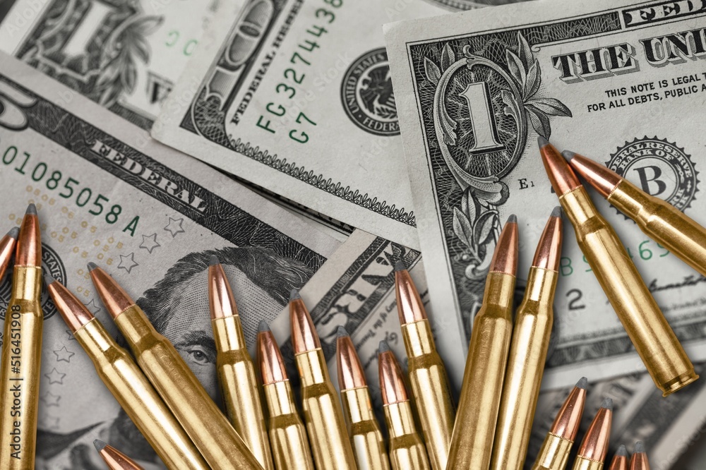 Cartridges with bullets in a bandolier, dollar bills. Concept: sale of ...