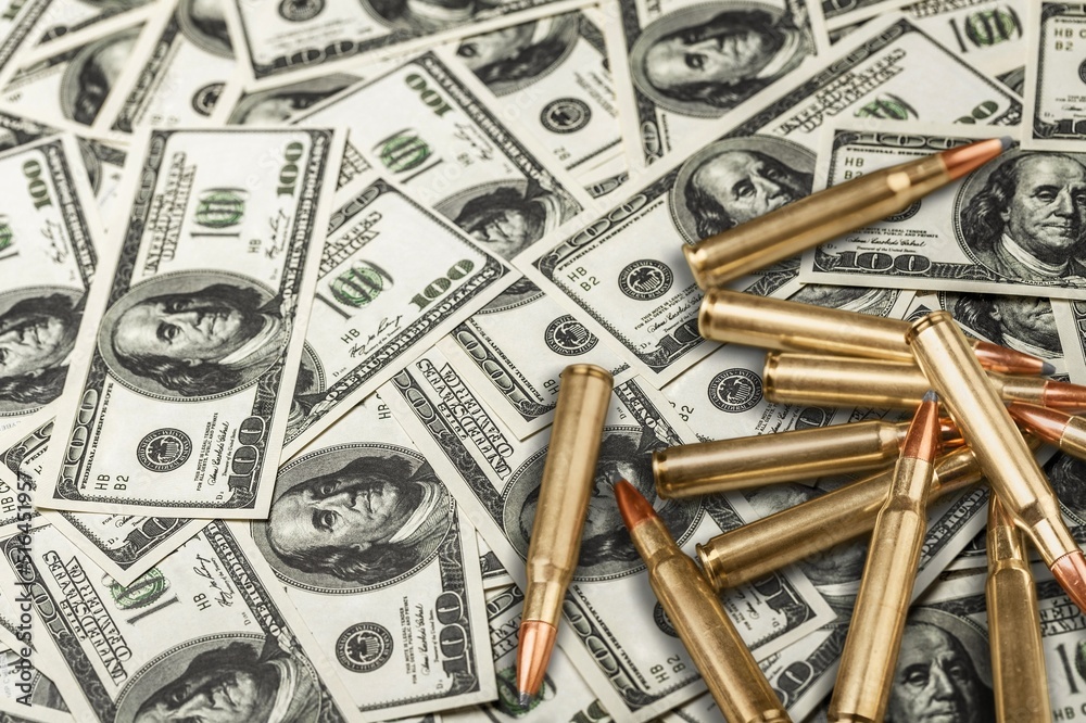 Cartridges with bullets in a bandolier, dollar bills. Concept: sale of ...