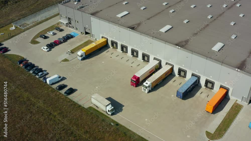 Drone shot logistics park with a warehouse loading hub.Semi-trailers ...