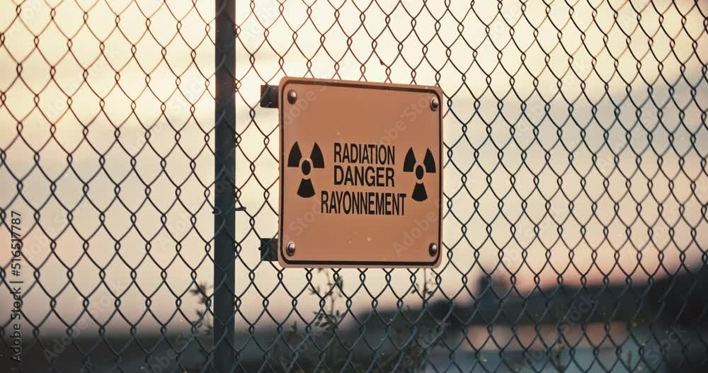 Close-up of Nuclear Radiation Danger Sign on Barbed Wire Perimeter ...