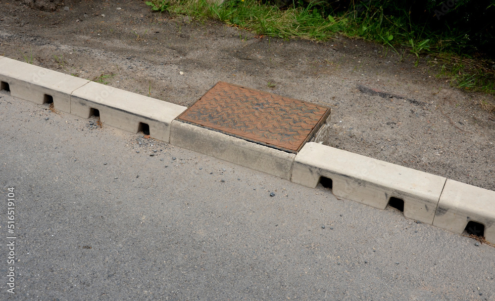 drainage hidden on the edge of an asphalt road Drainage system hidden ...