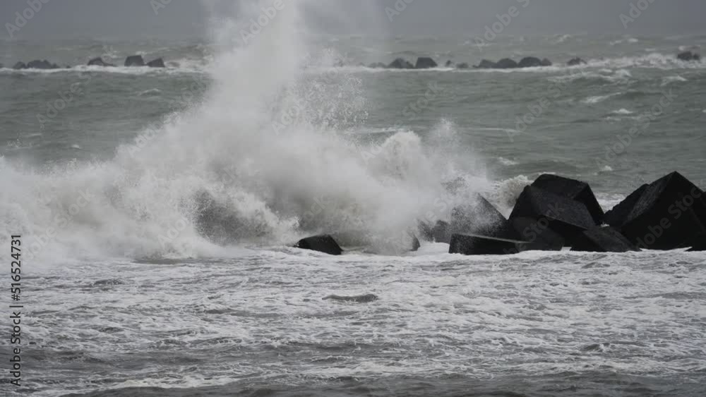 A stationary footage of huge waves and splashes of water due to ...