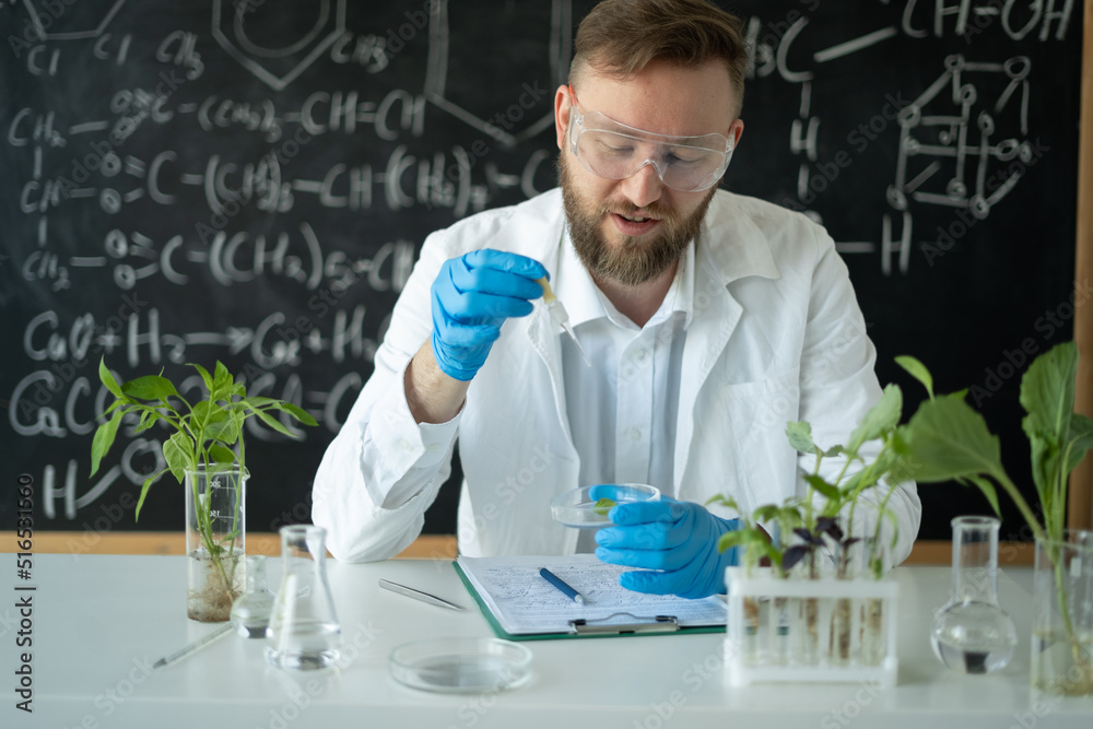 Laboratory research scientist man conducts experiments in a ...