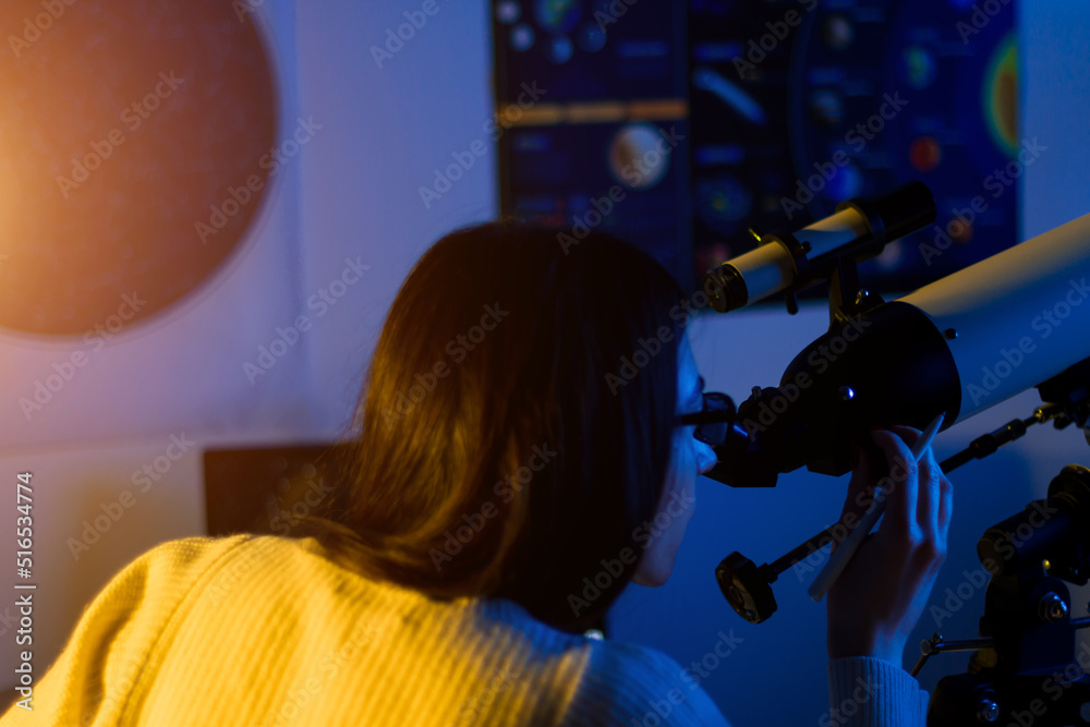 Astronomer woman looks through telescope at night sky, space, cosmos ...