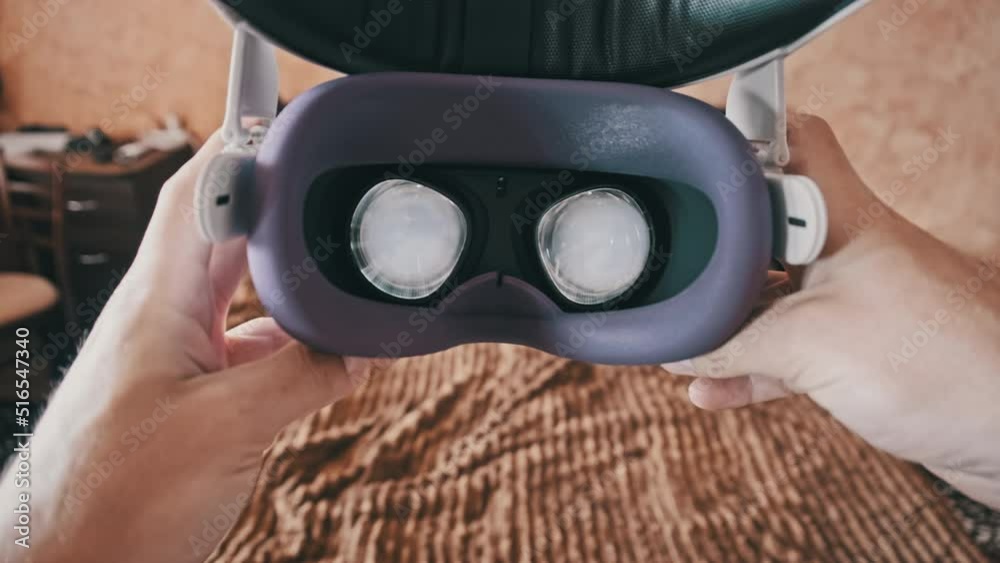POV of putting on VR glasses virtual reality in the bedroom. Young male ...