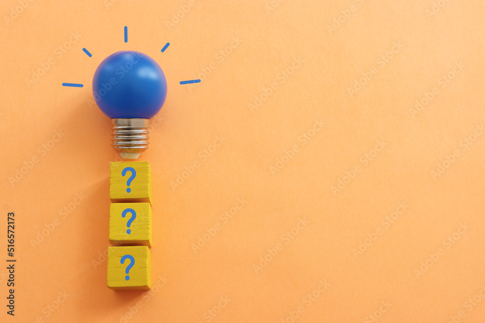 Question mark and light bulb over orange background, concept of idea ...
