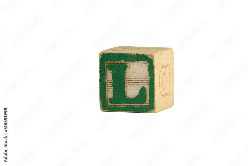 Distressed vintage green and white toy block, photographed against a ...