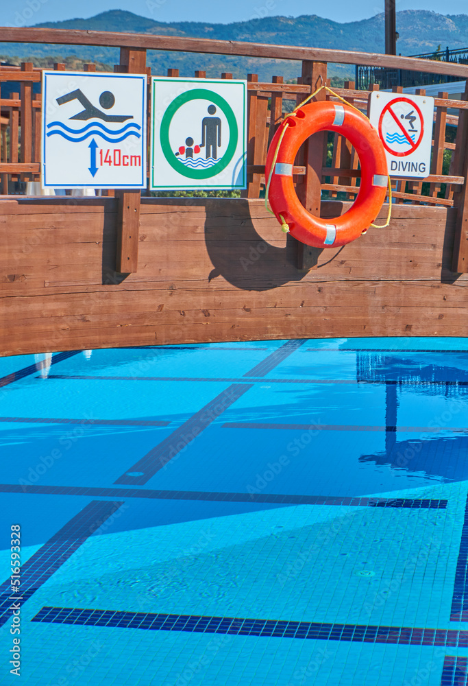 Lifebuoy, pool dept and no diving signs next to each other Stock Photo ...