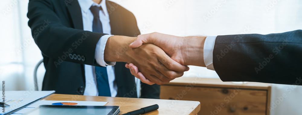 client and banker shaking hands on the meeting table after business ...