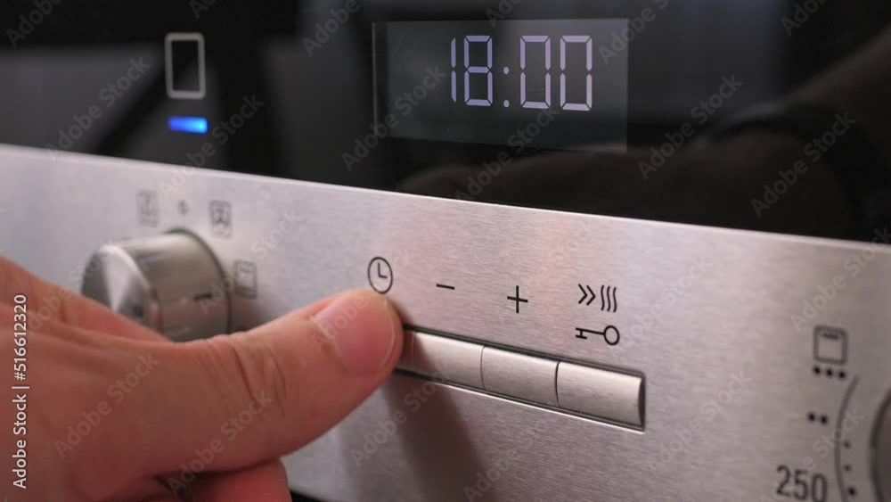 Turning on the mode switch and setting the time on electric oven. Male ...