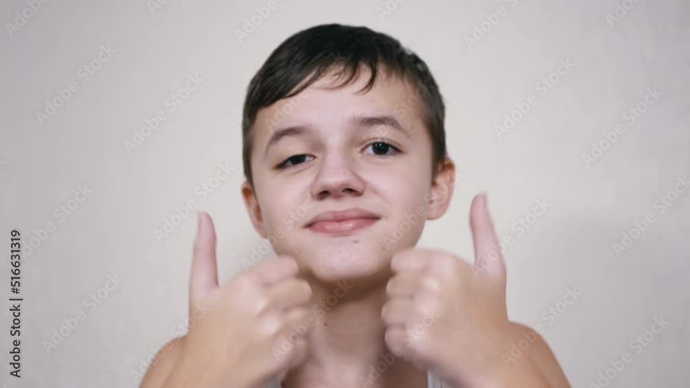 Positive Boy Holding Thumbs Up in front of the Camera, Showing a Sign ...