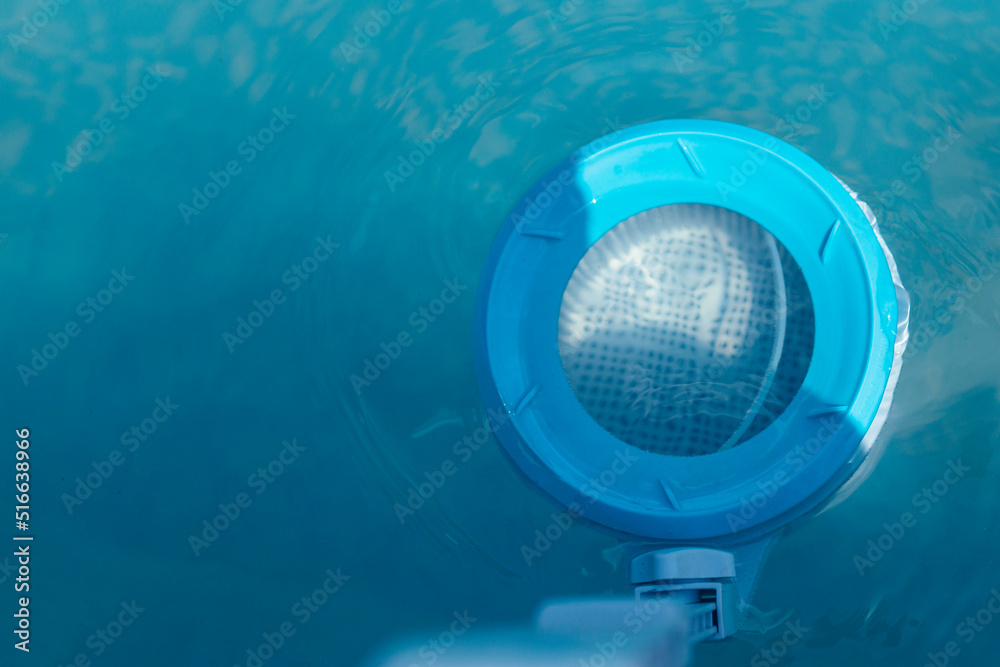 Top view of the skimmer for cleaning the pool in clear water. Close-up ...