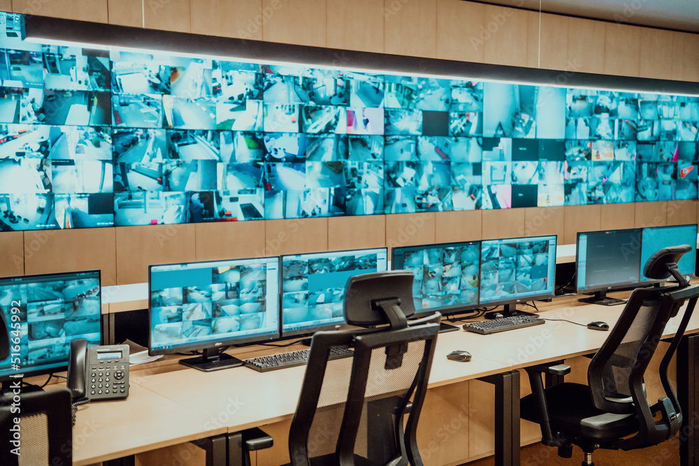 Empty interior of big modern security system control room, workstation ...